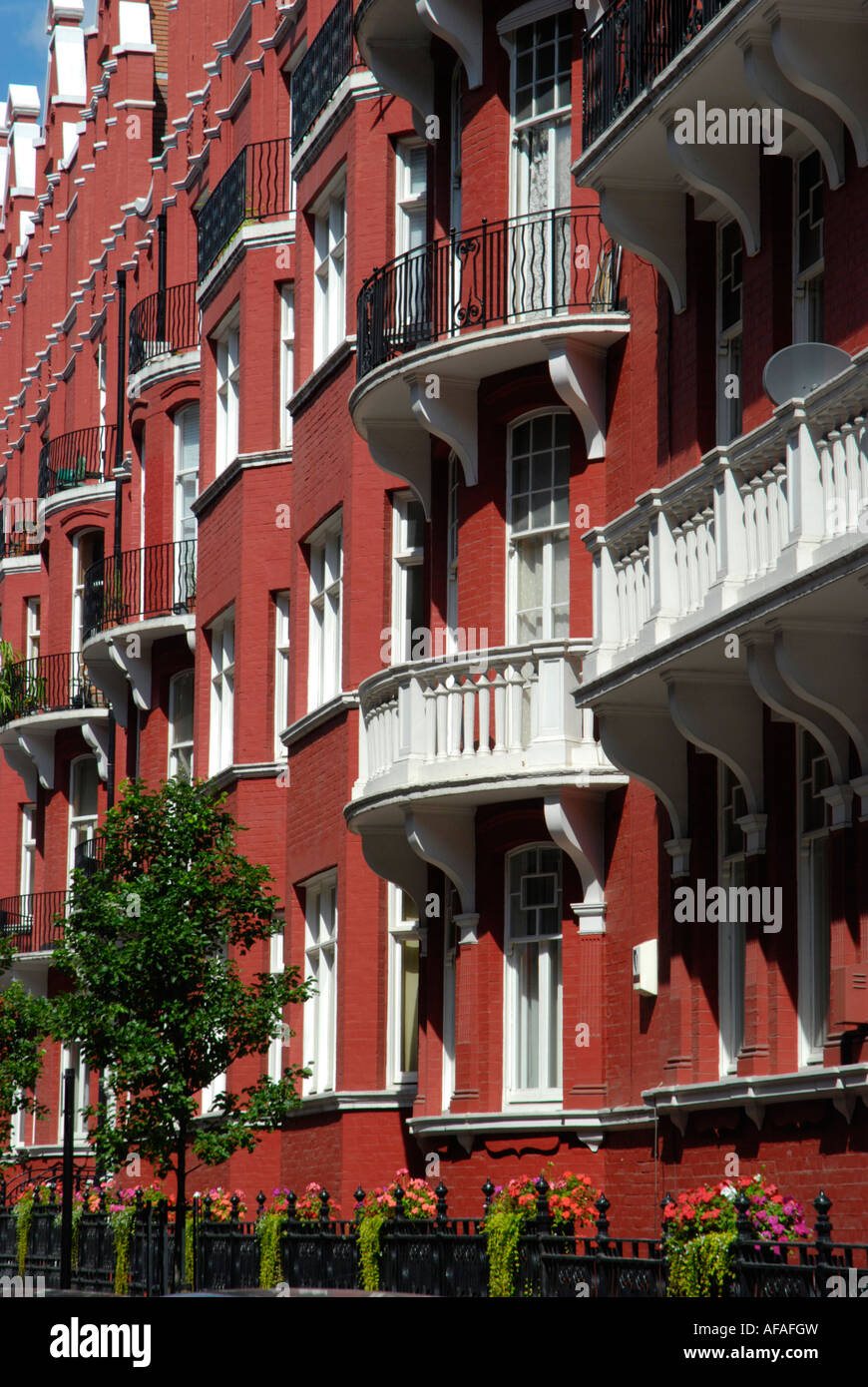 Red painted mansion apartment buildings Stock Photo - Alamy