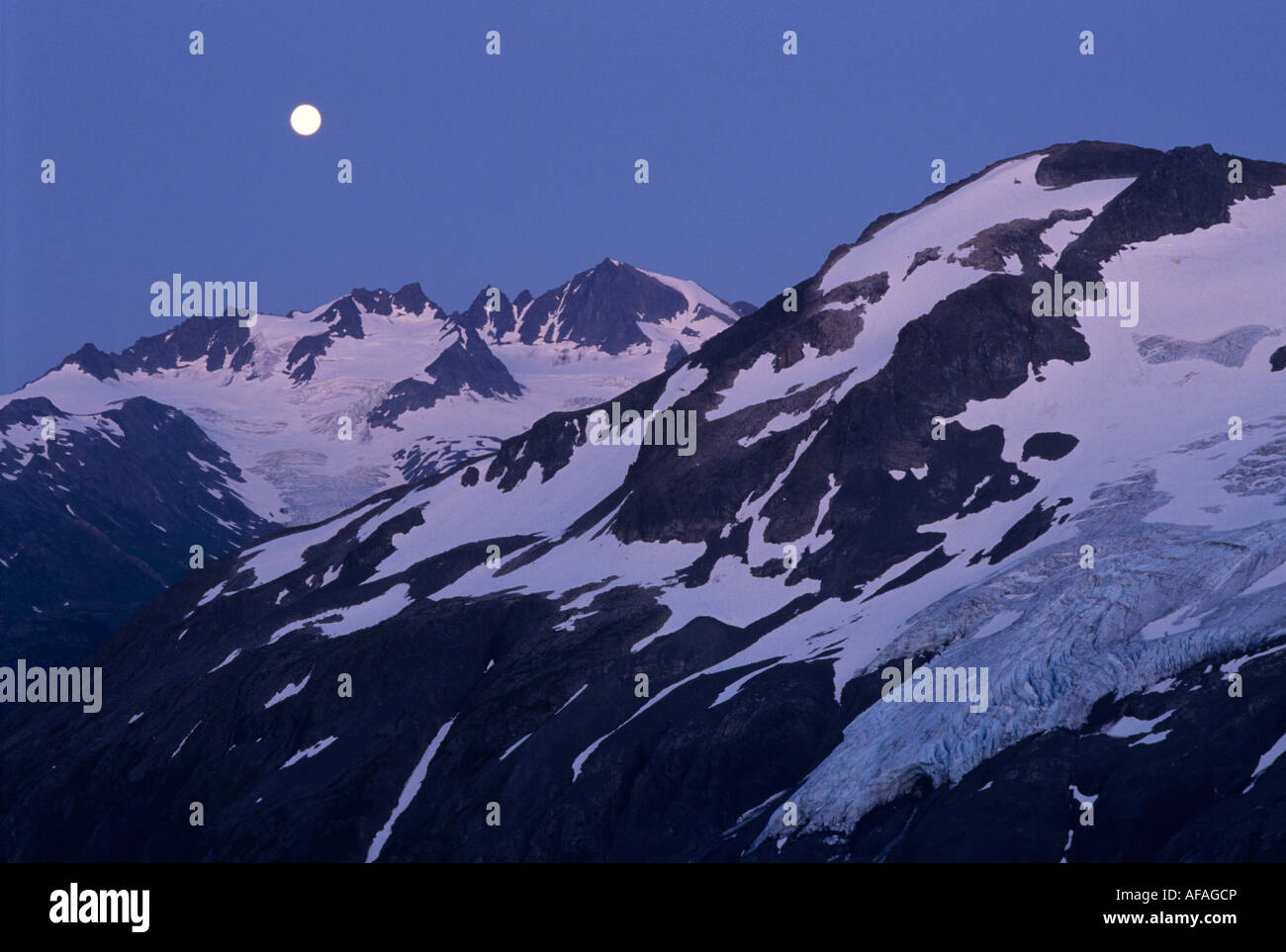 USA Alaska Kenai Fjords National Park Full moon rises above Kenai Range ...