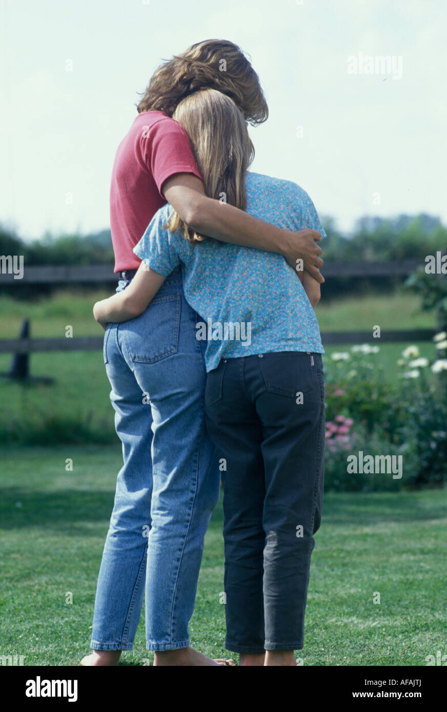 back view of mother and daughter hugging Stock Photo - Alamy