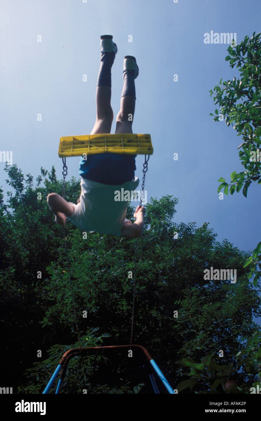 child swinging high on a swing as seen from below Stock Photo - Alamy