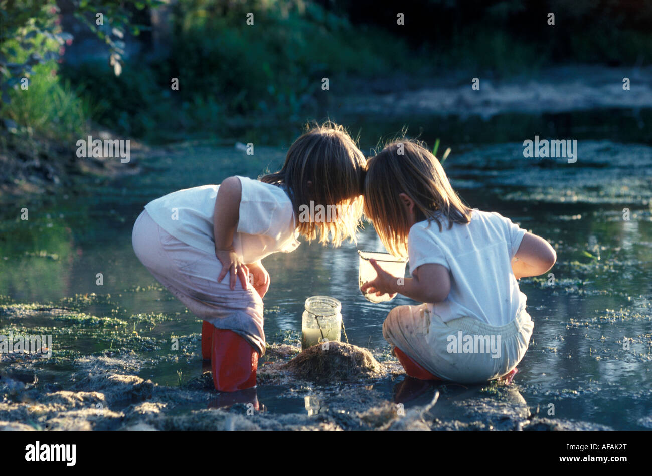 two young children fishing in a stream Stock Photo - Alamy
