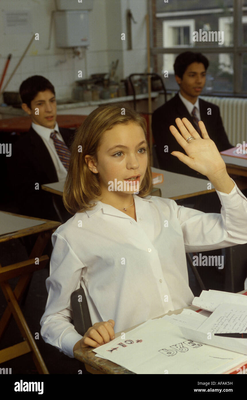 girl with hand up in class Stock Photo - Alamy