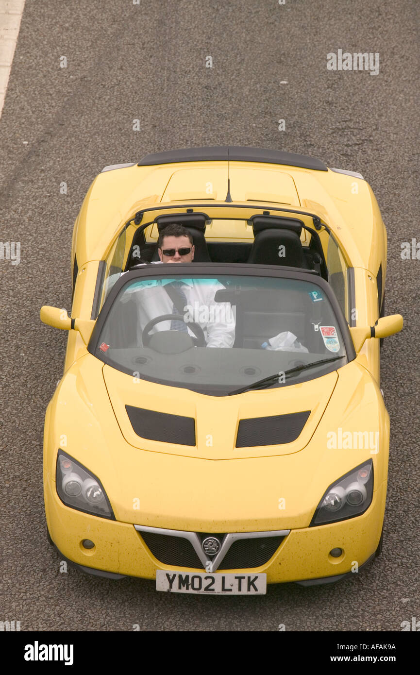 an open topped sports car on the M1 motorway at Kegworth Leicestershire ...