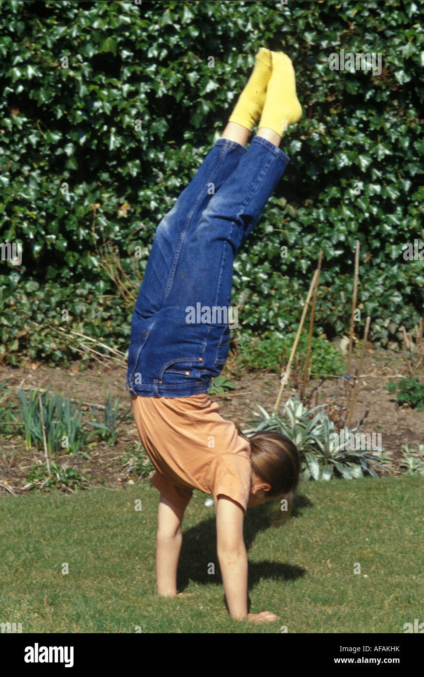 Child doing headstand hi-res stock photography and images - Alamy