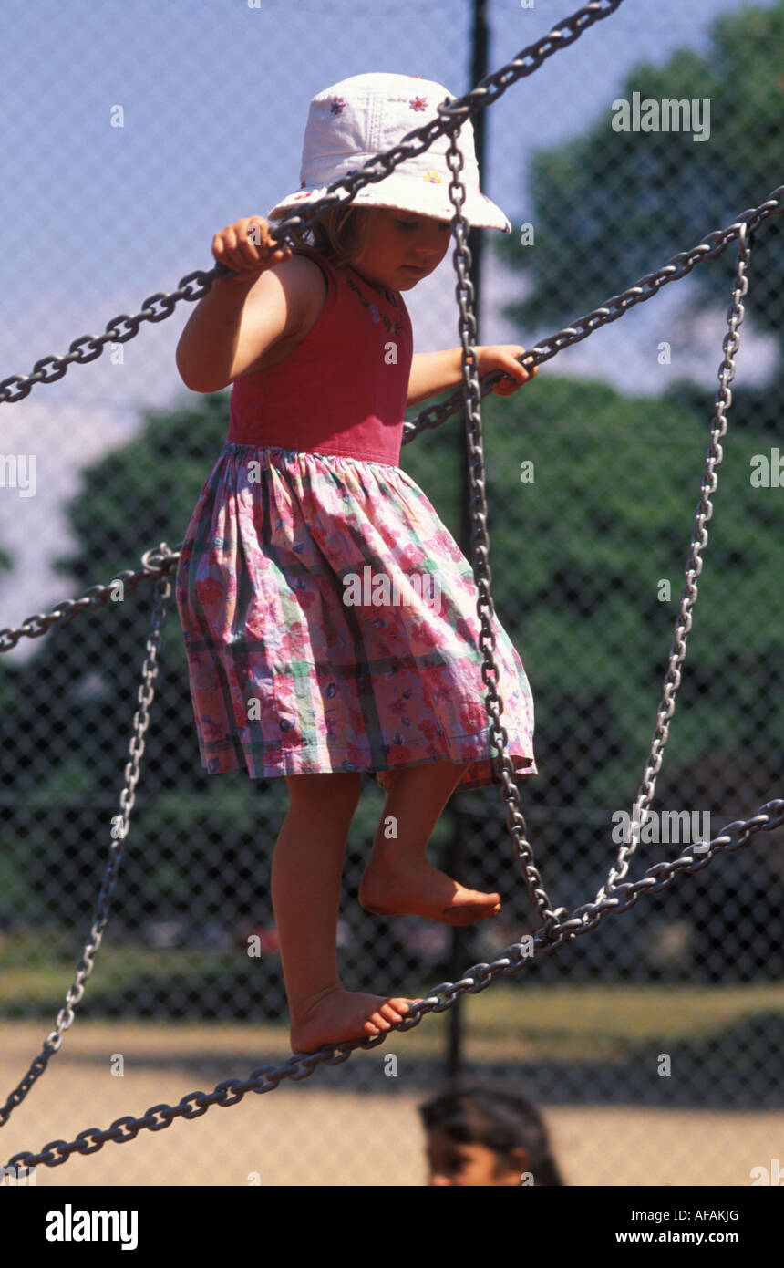girl walking along a chain tight rope Stock Photo - Alamy
