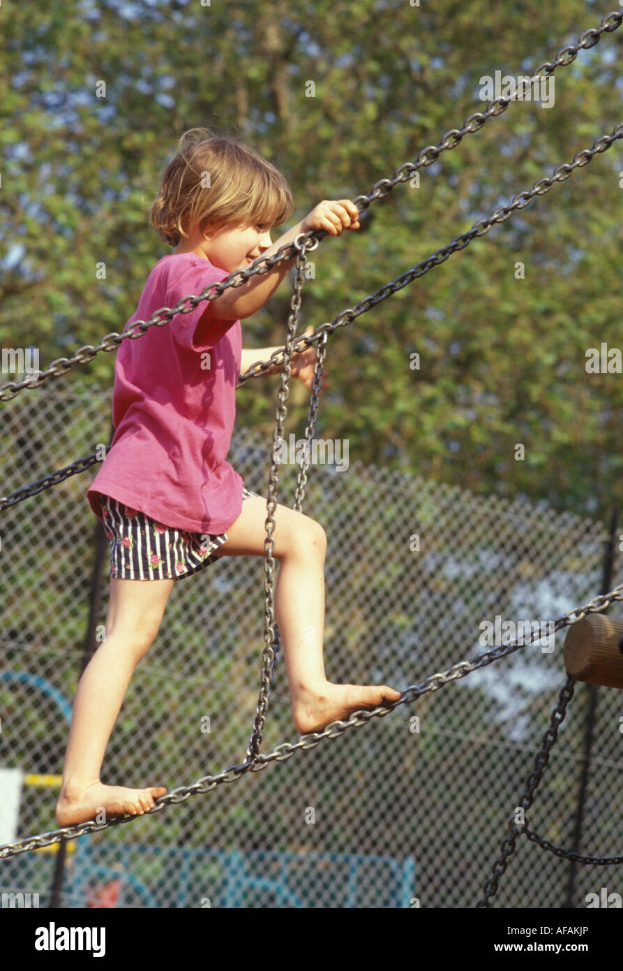 girl walking along a chain tight rope Stock Photo - Alamy