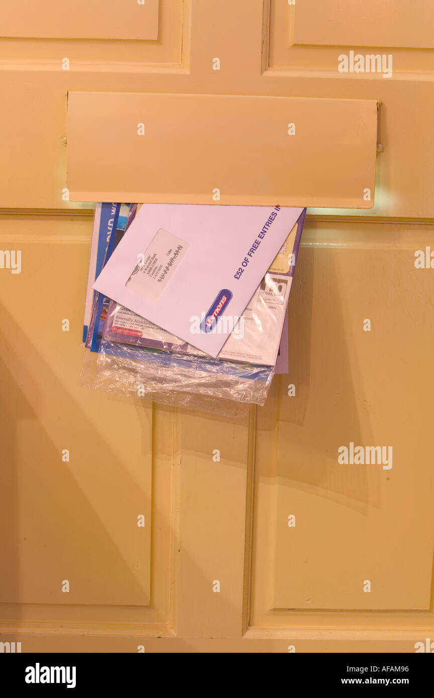 post coming through a letterbox of a house front door Stock Photo - Alamy