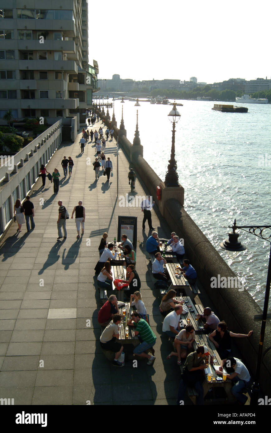 People relaxing along the River Thames at Bankside London Stock Photo ...