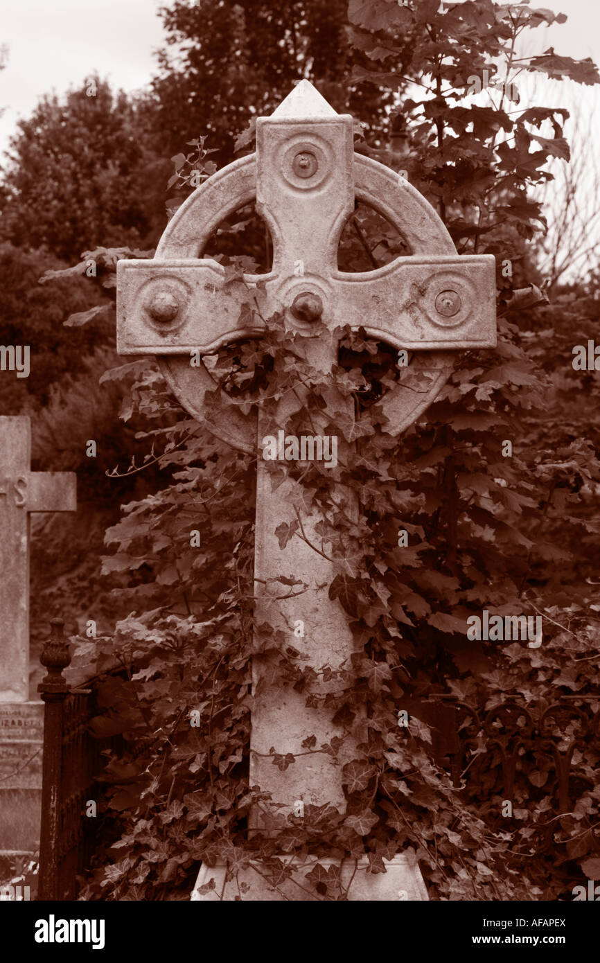 A tombstone cross in a graveyard with sepia look Stock Photo - Alamy