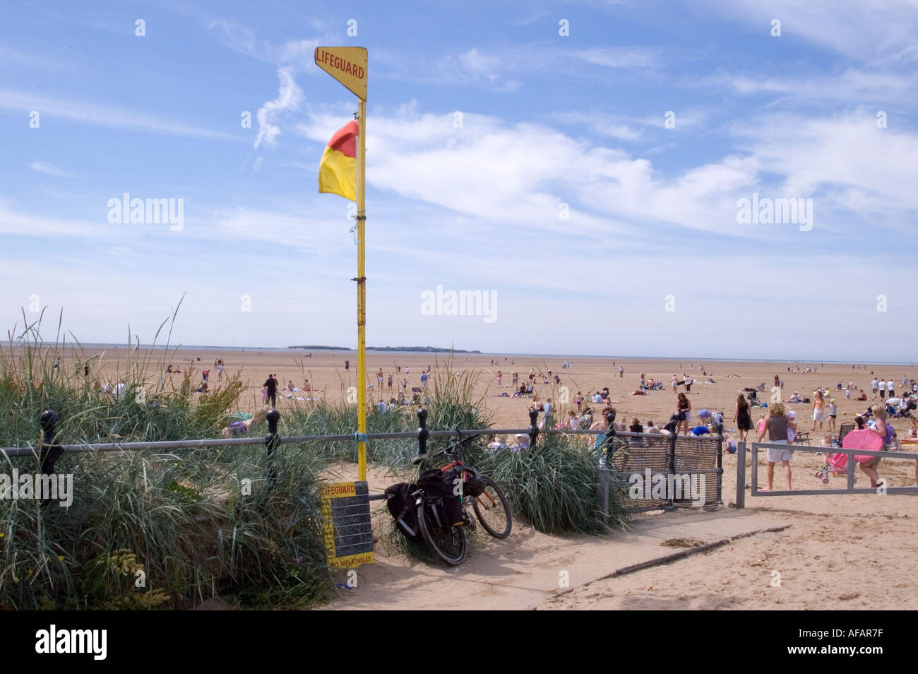 LIfegaurd flag on beach at West Kirby on the Wirral Stock Photo - Alamy