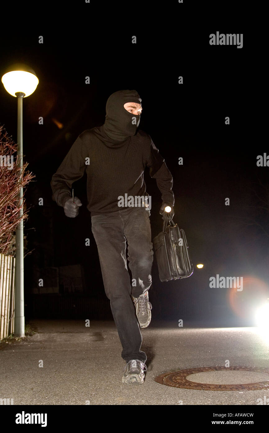 Burglar on the run Stock Photo - Alamy
