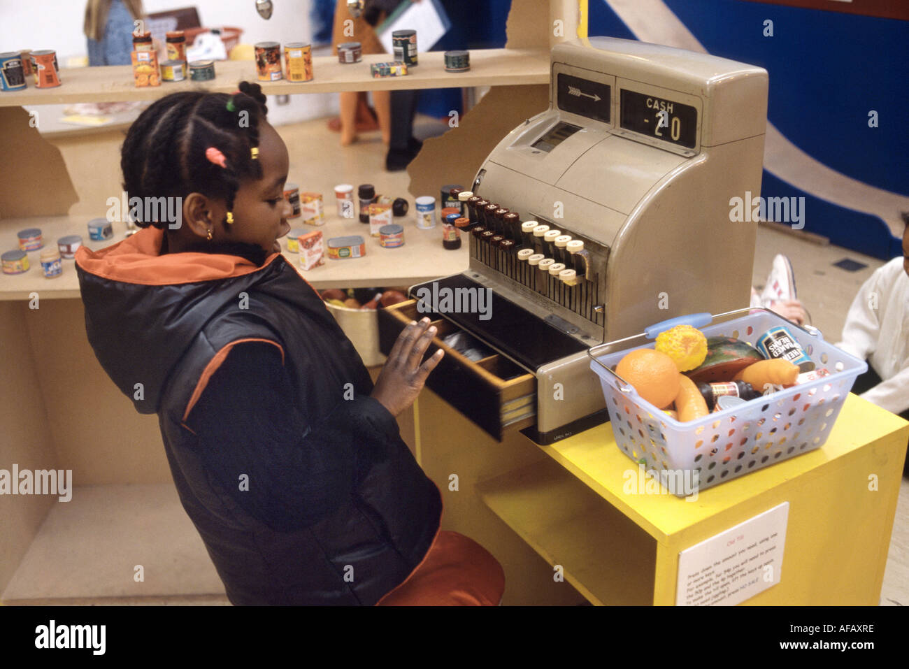 primary school girl playing in a toy store Stock Photo - Alamy