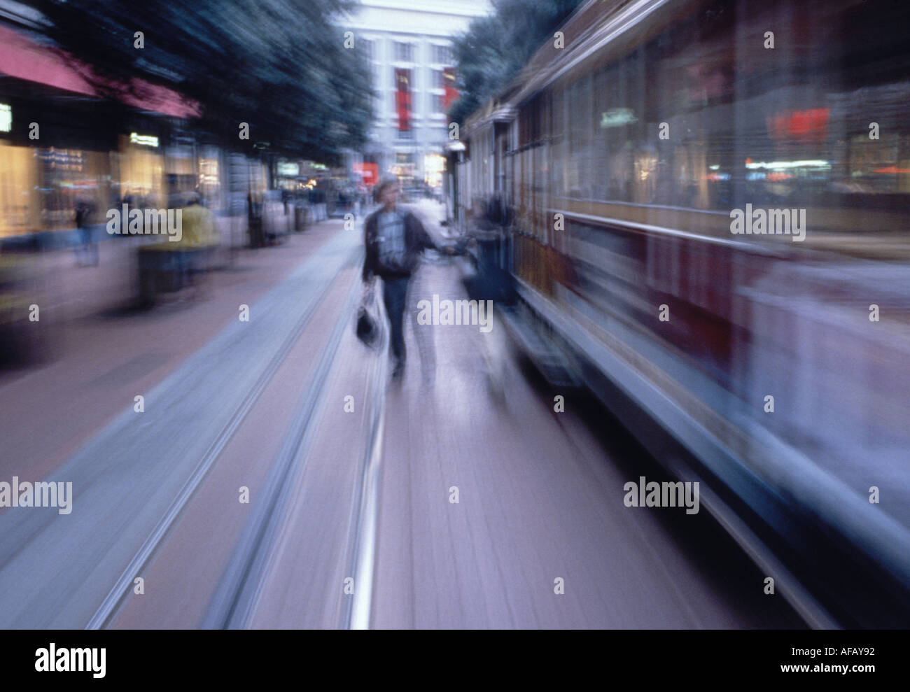 Businessman steps off a moving cable car onto Market Street San ...