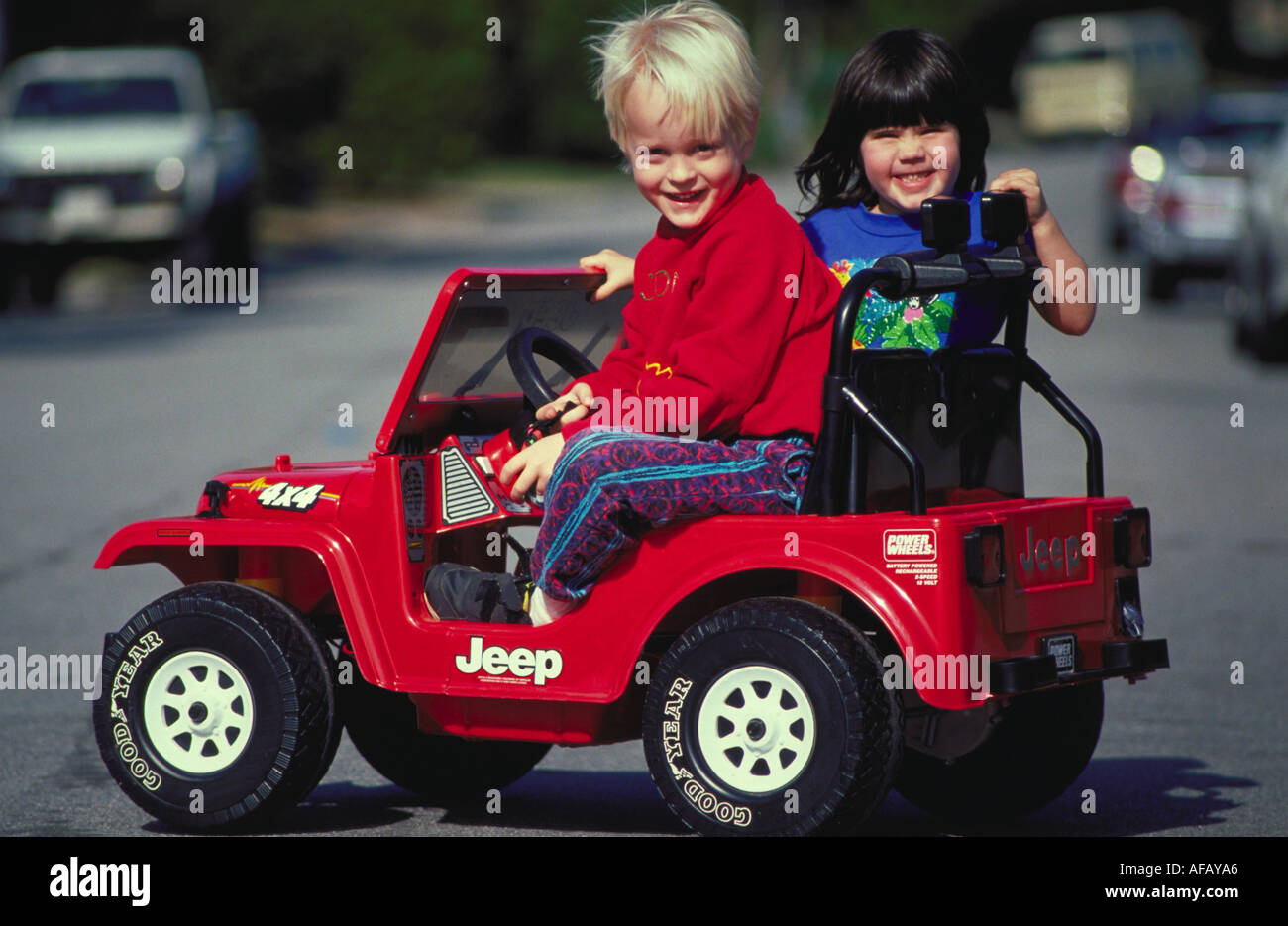 Two children looking back and smiling as the ride in a miniature ...