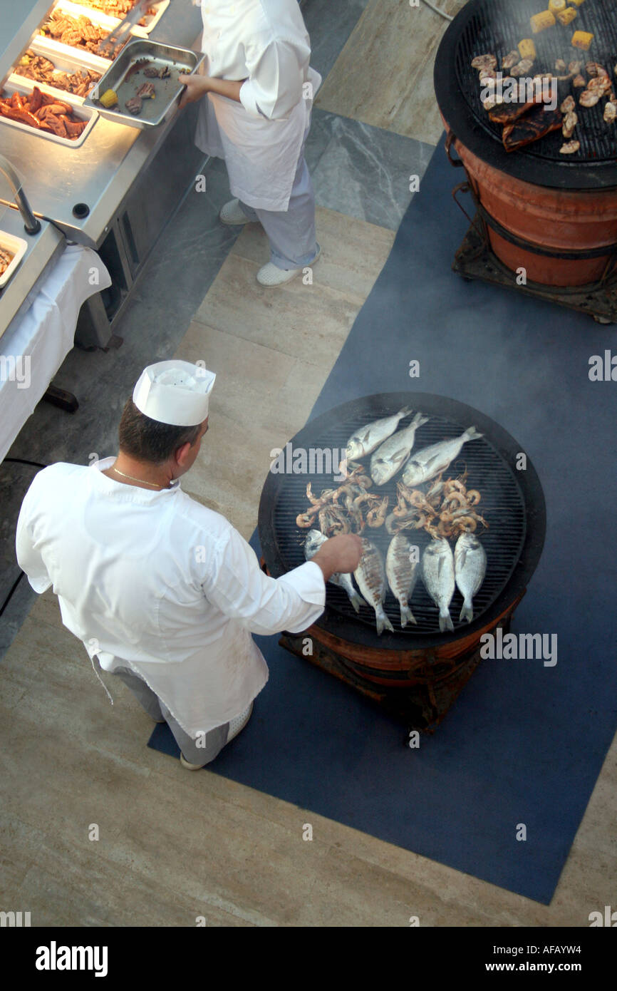 GREEK CHEF COOKING FOOD ON A BARBECUE ON THE ISLAND OF CRETE Stock ...