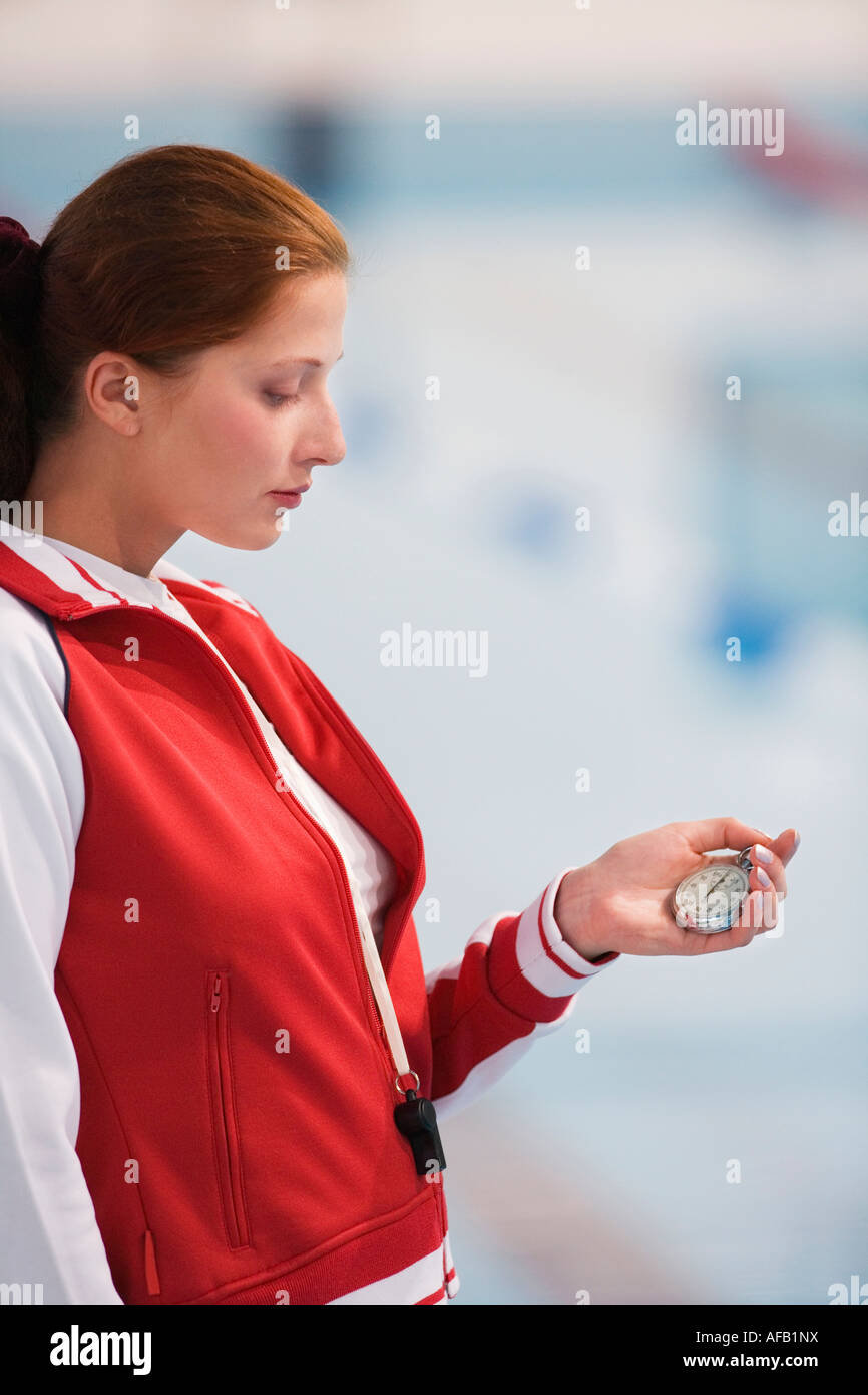Young woman holding stop watch Stock Photo - Alamy
