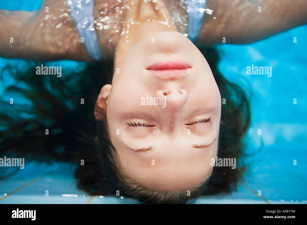 Woman drifting in water Stock Photo - Alamy
