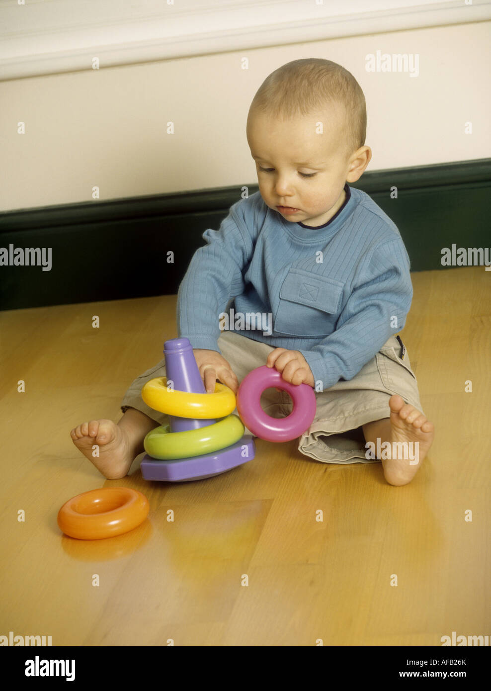 Baby boy playing with "stacking ring" toy Stock Photo - Alamy