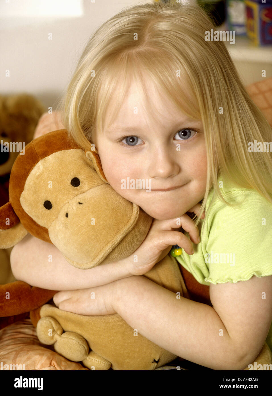 Young girl cuddling a soft toy Stock Photo - Alamy
