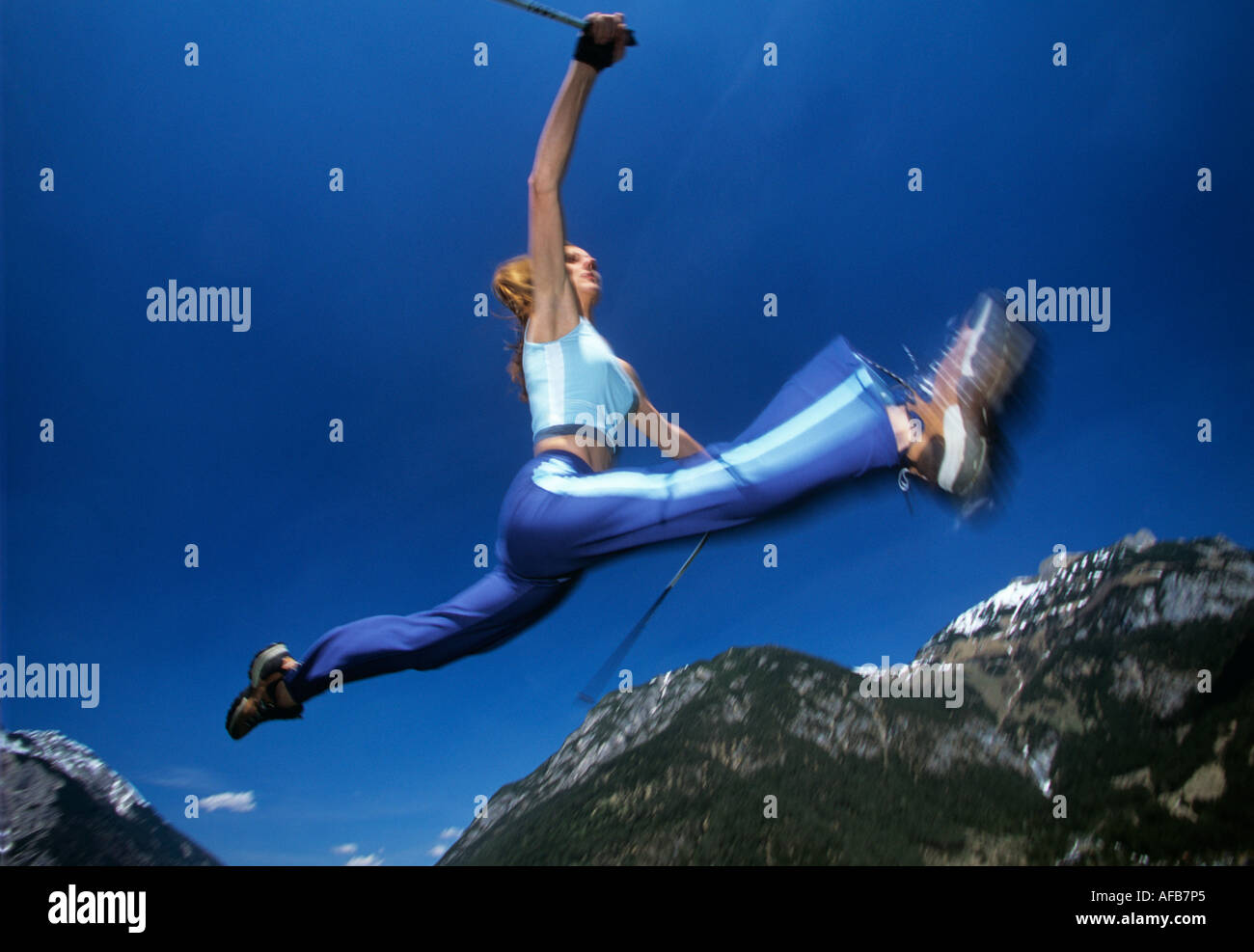 low angle view of jumping woman in nordic walking outfit Stock Photo ...
