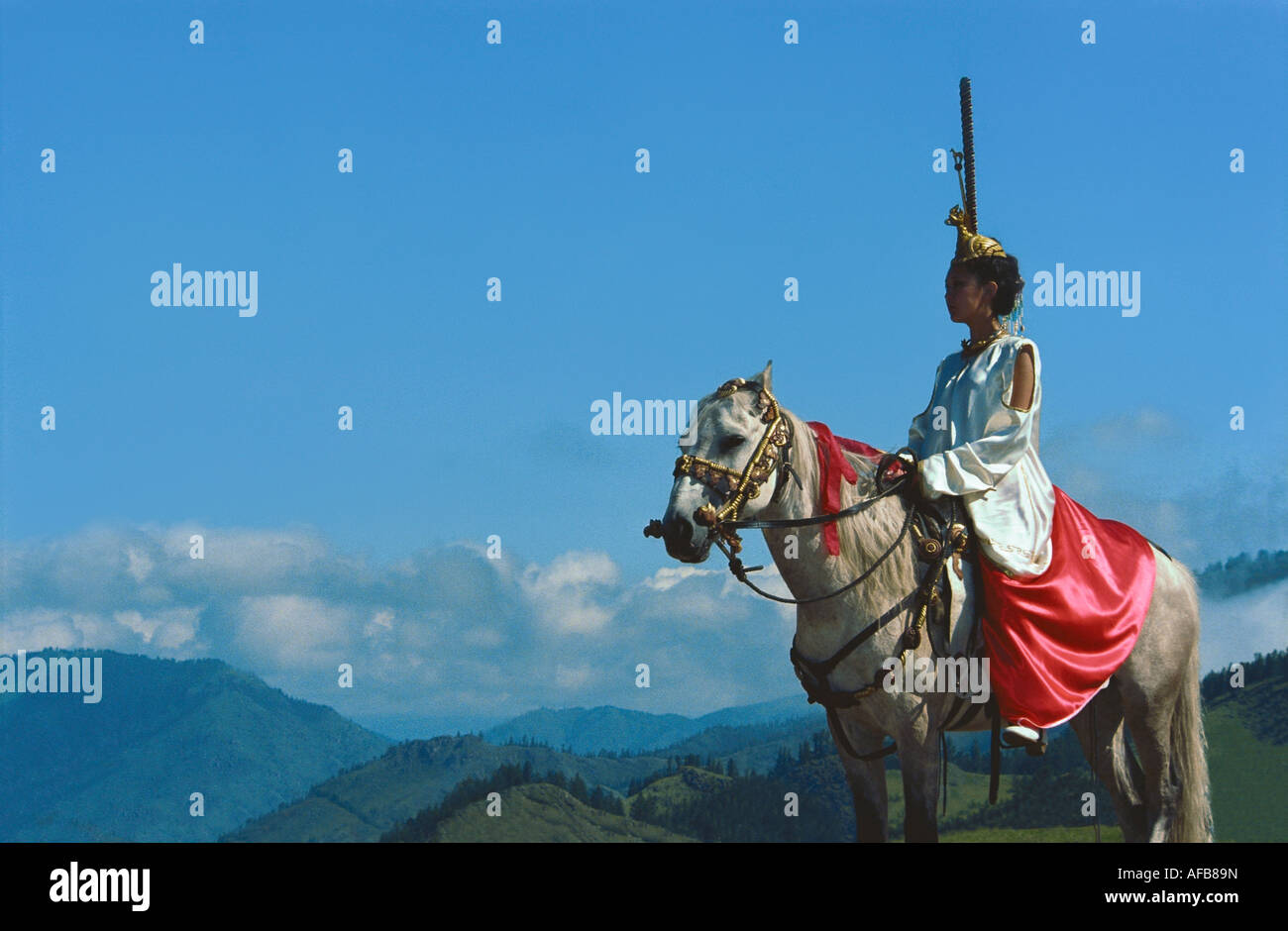Horse-riding woman in raiment created in Pazyryk culture style. El-Oiyn ...