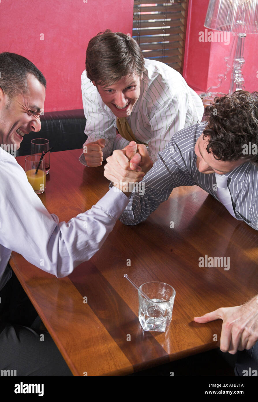group of friends arm wrestling in bar Stock Photo - Alamy