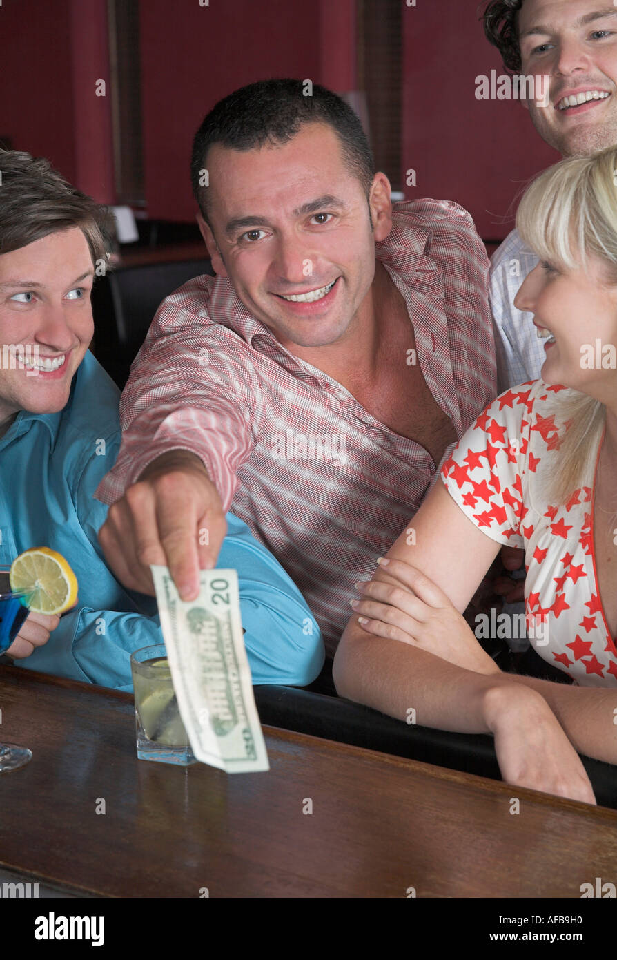 young man paying for his friends at bar Stock Photo - Alamy