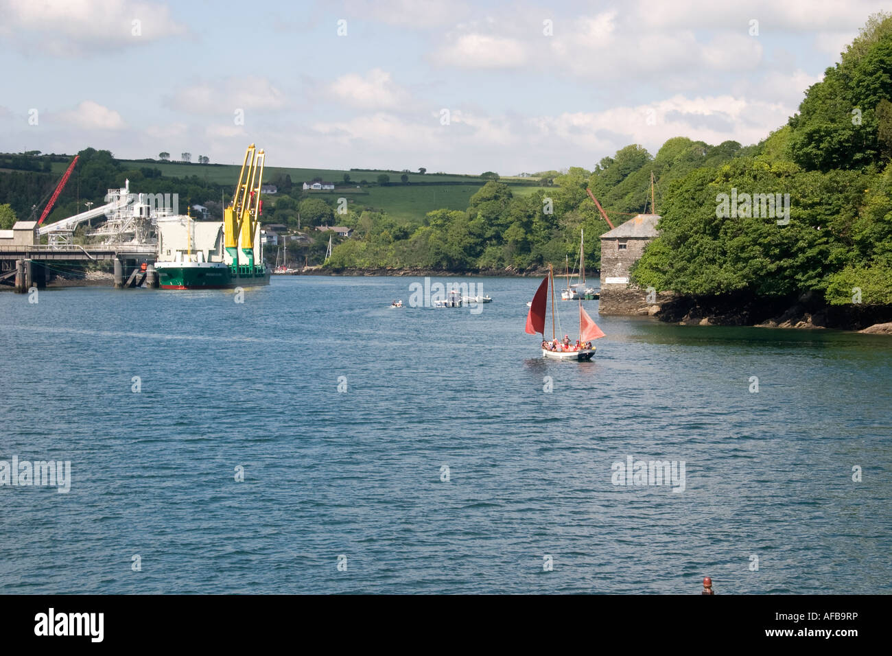 Traditional sailing dinghy with mizzen mast sails the Fowey River Stock ...