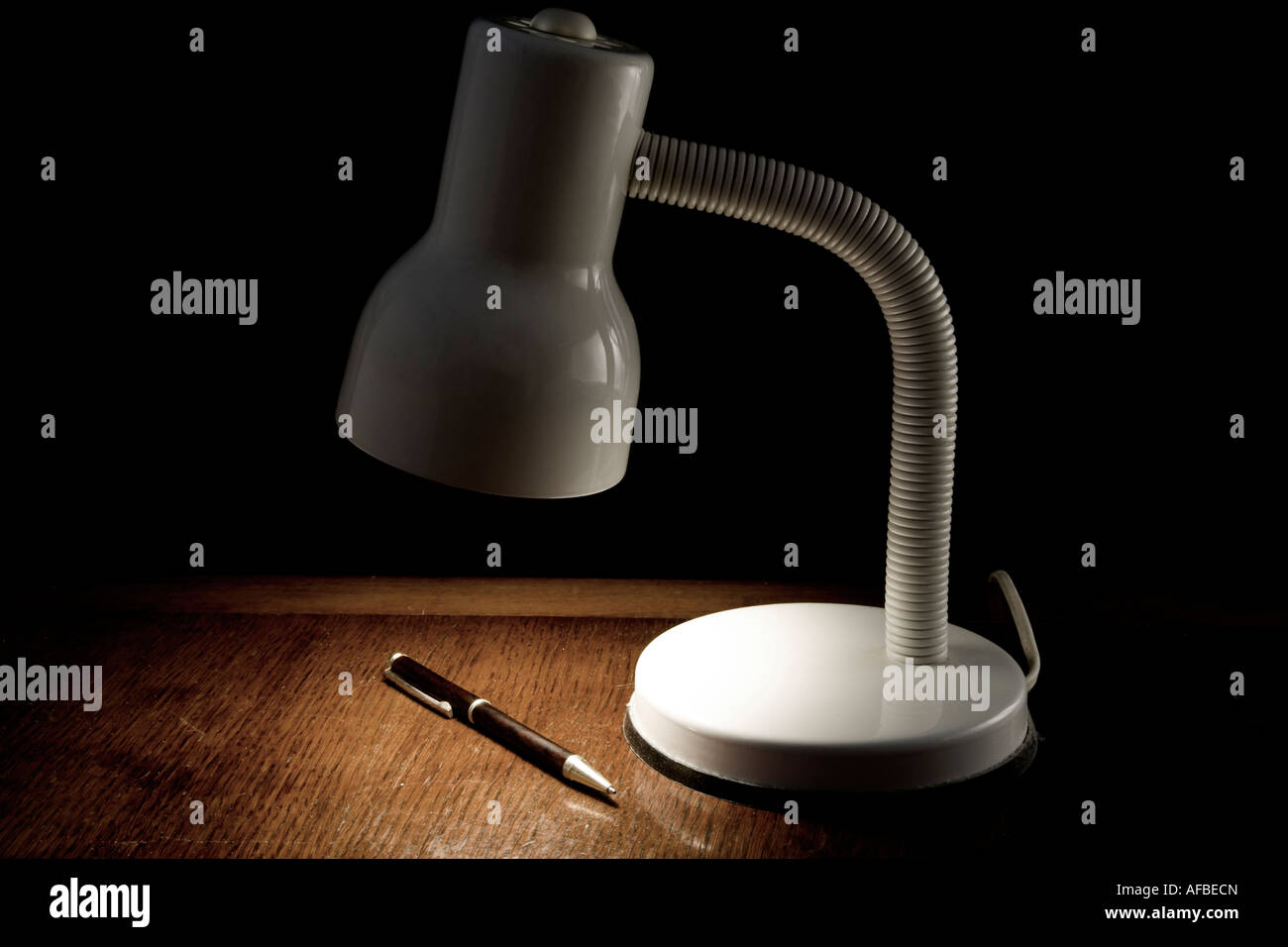 A pen under the light of a table lamp Stock Photo - Alamy
