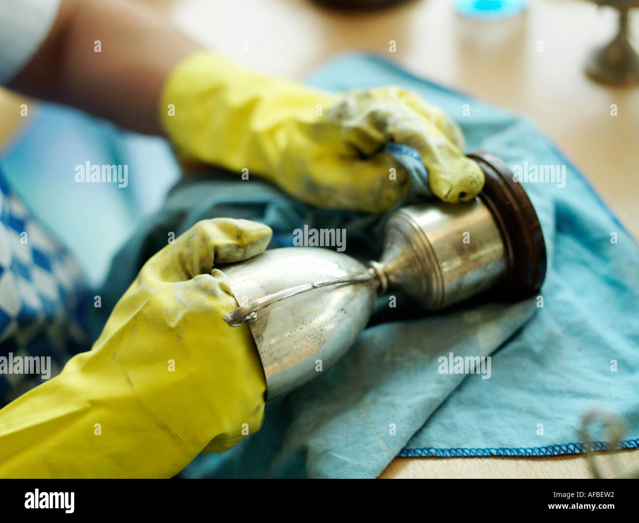 Awoman polishing a trophy Stock Photo - Alamy