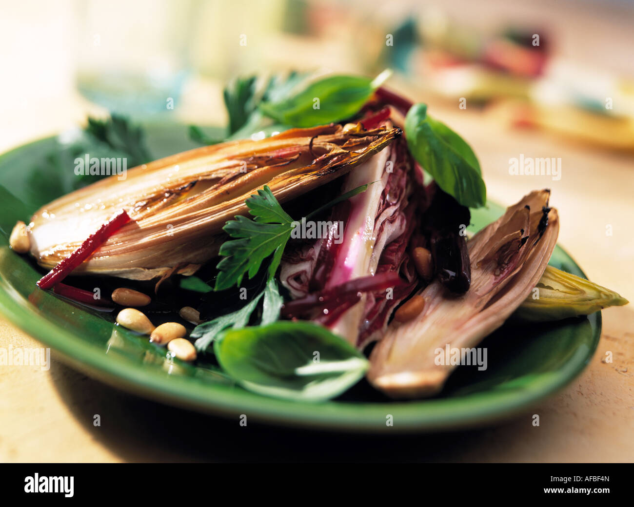A dish of grilled chicory Stock Photo - Alamy
