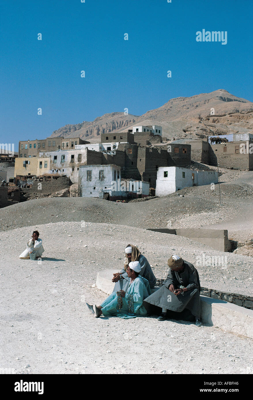 Villagers in traditional dress outside their village of painted Arab ...