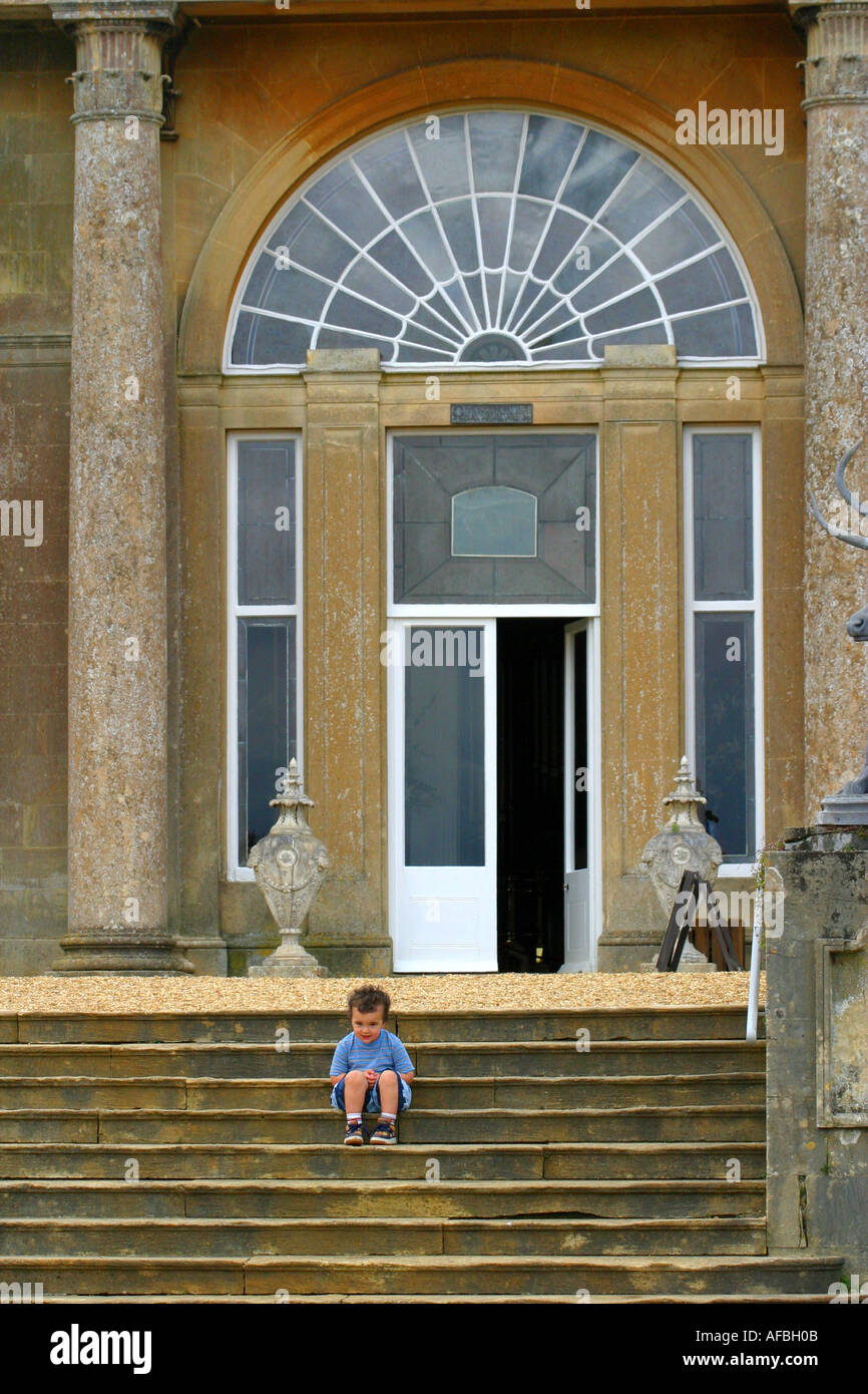 Small boy sitting on stairs hi-res stock photography and images - Alamy