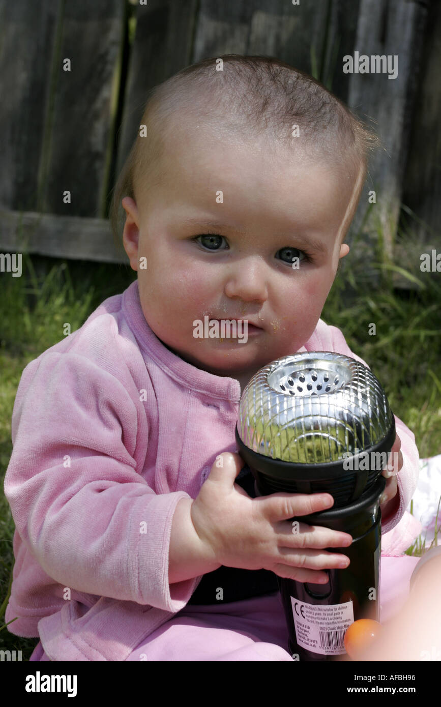 Baby girl with giant karaoke microphone Stock Photo - Alamy