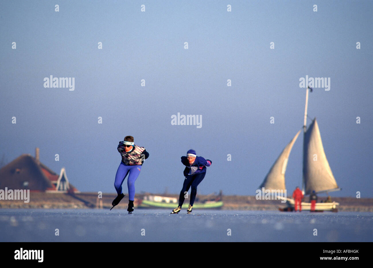 Netherlands Monnickendam Man skating on frozen lake Gouwzee with ice ...