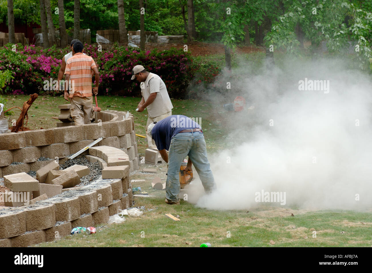 Workers building a wall Stock Photo - Alamy