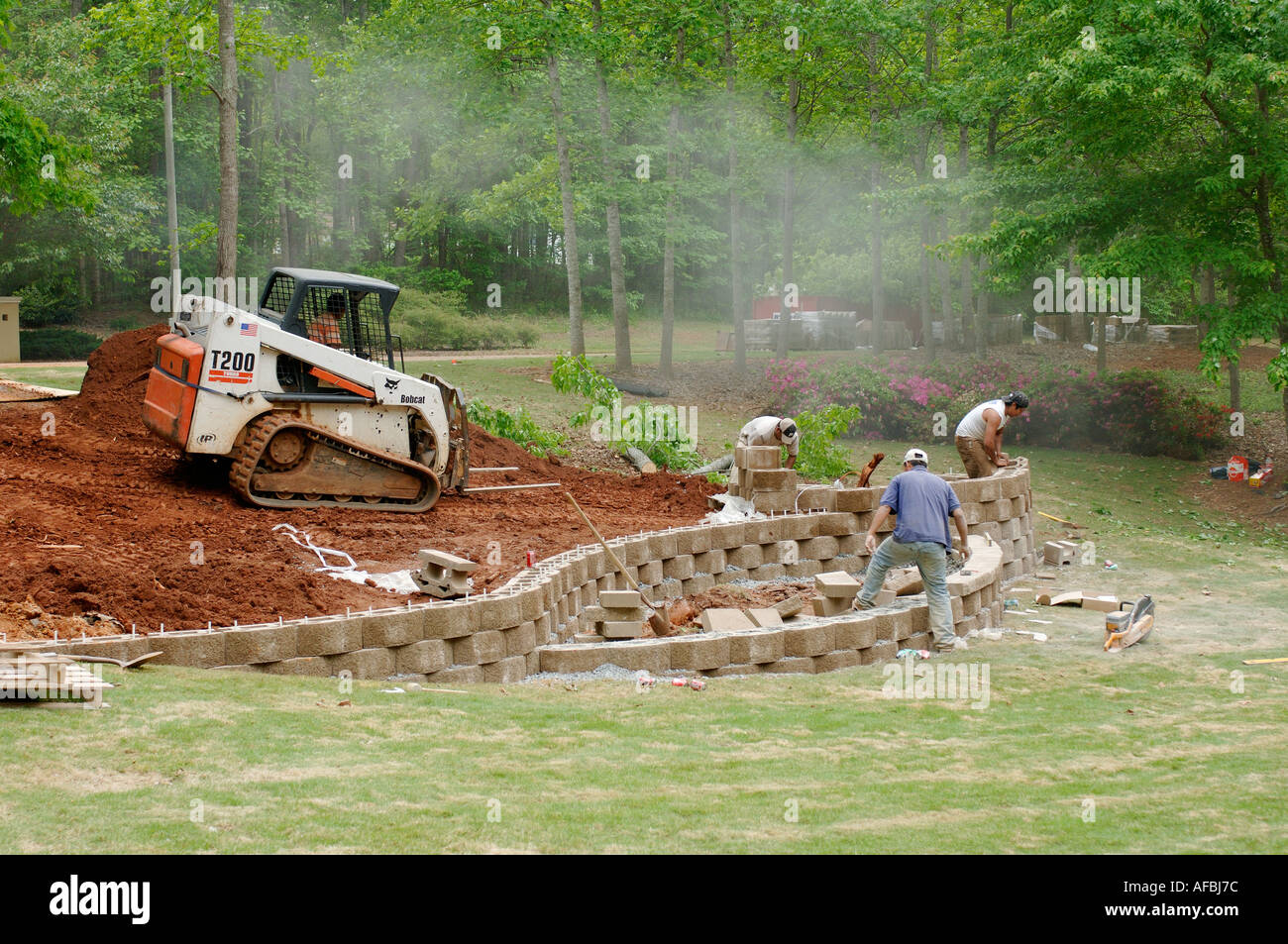 Workers building a wall Stock Photo - Alamy