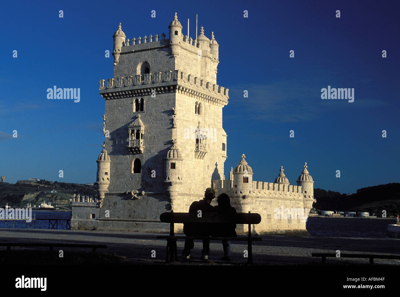 Lisbon romantic couple sitting in front of the Belem castle tower Stock ...