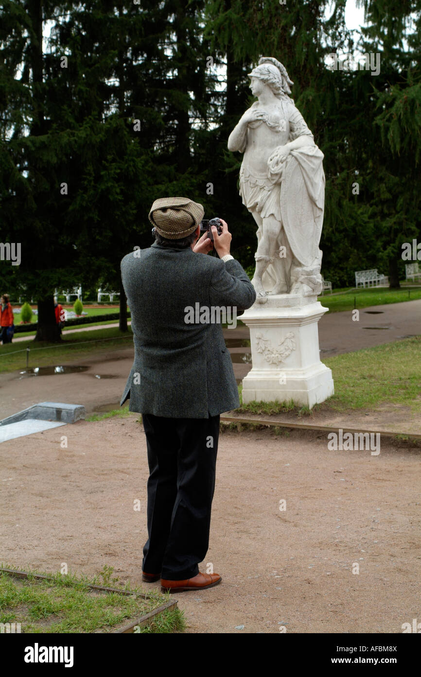 Man using digital camera to photograph a statue Tourist taking photo at ...