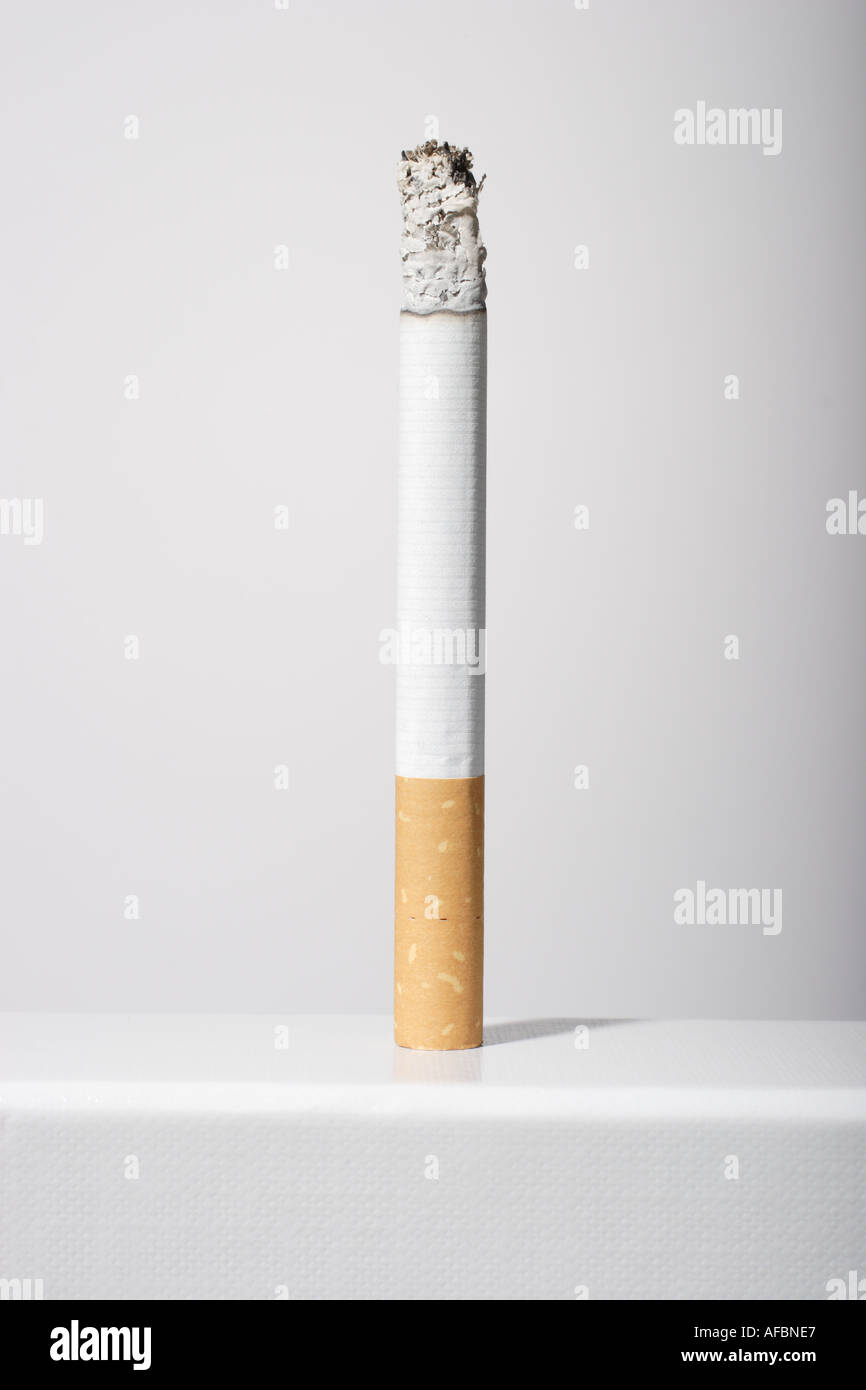 Burning cigarette upright standing Stock Photo - Alamy