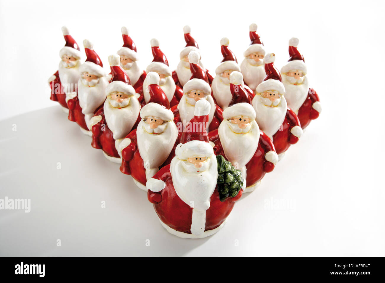 Santa claus figurines standig in form of a triangle Stock Photo - Alamy
