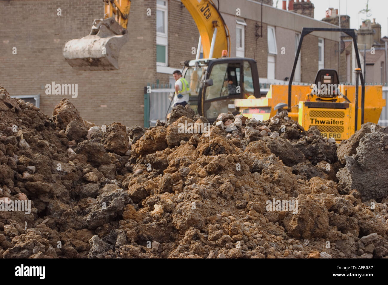Rubble on building site with JCB Stock Photo - Alamy