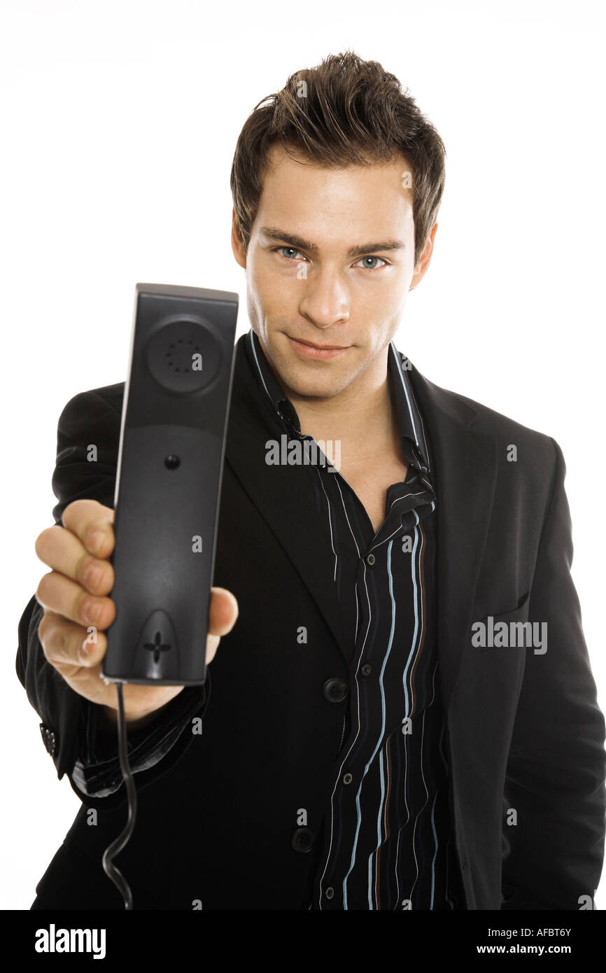 Young man holding receiver, close-up Stock Photo - Alamy