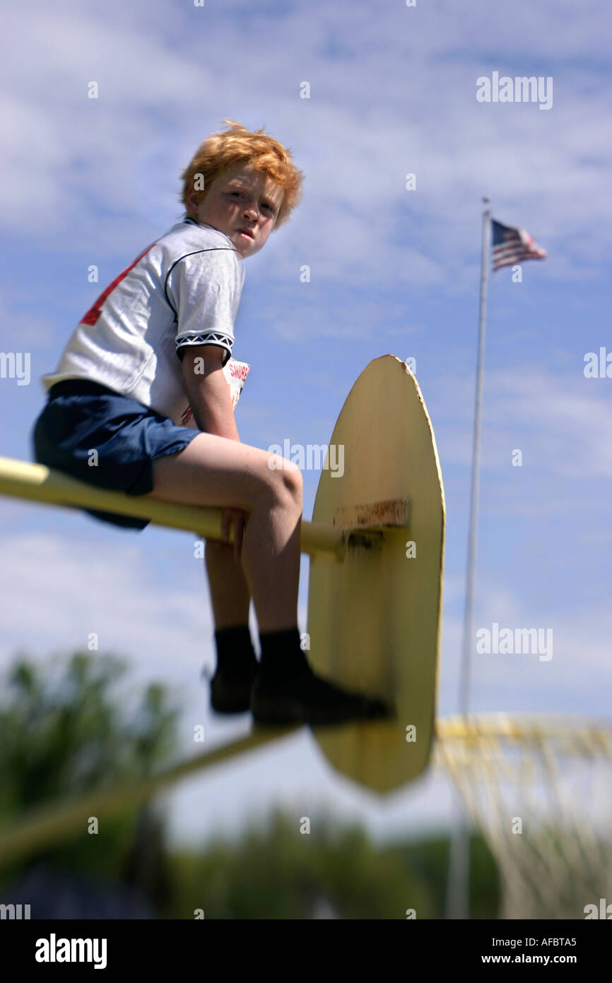 Boy on Basketball Hoop Watching Parade Stock Photo - Alamy