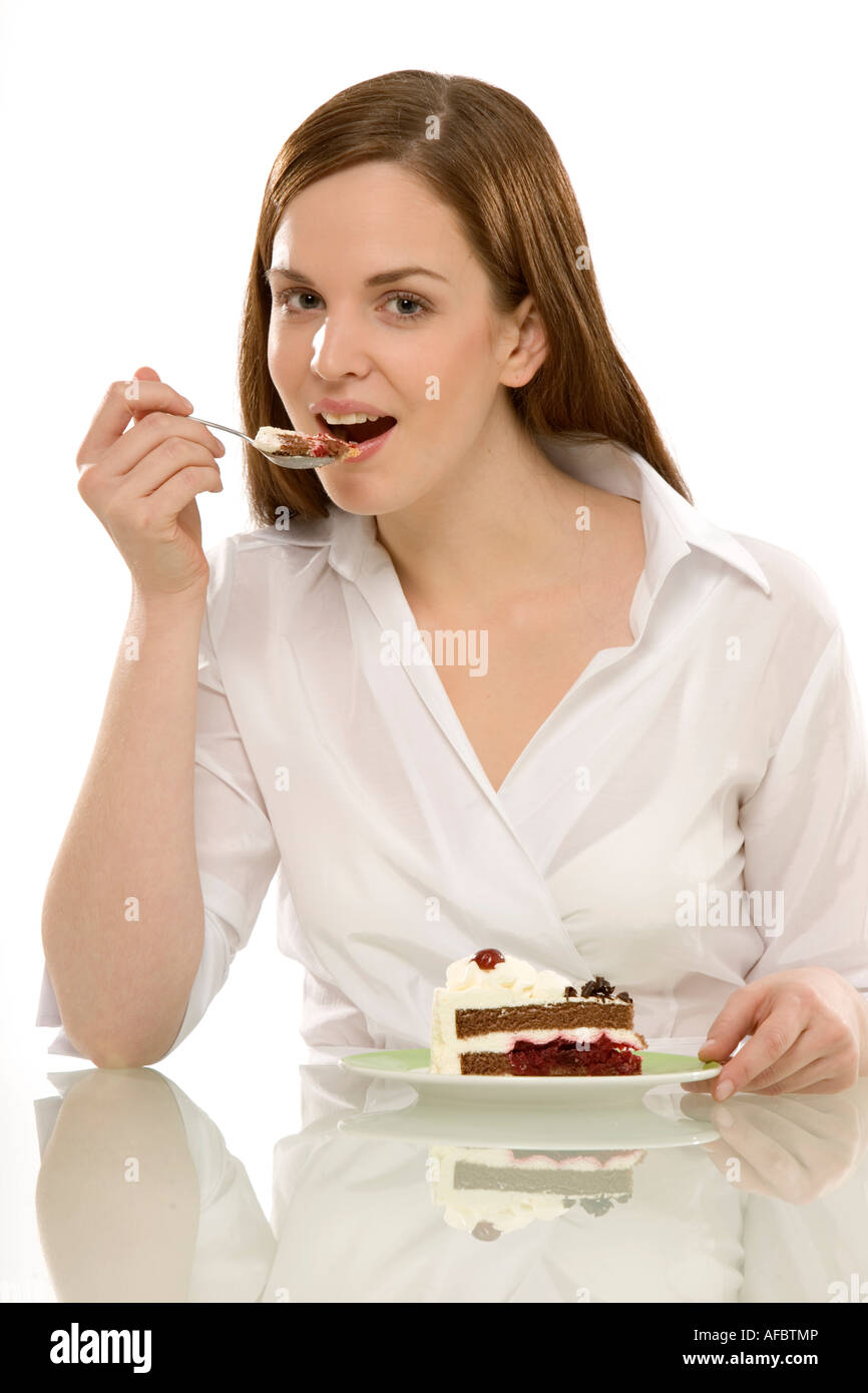 Young woman eating piece of cake, portrait Stock Photo - Alamy