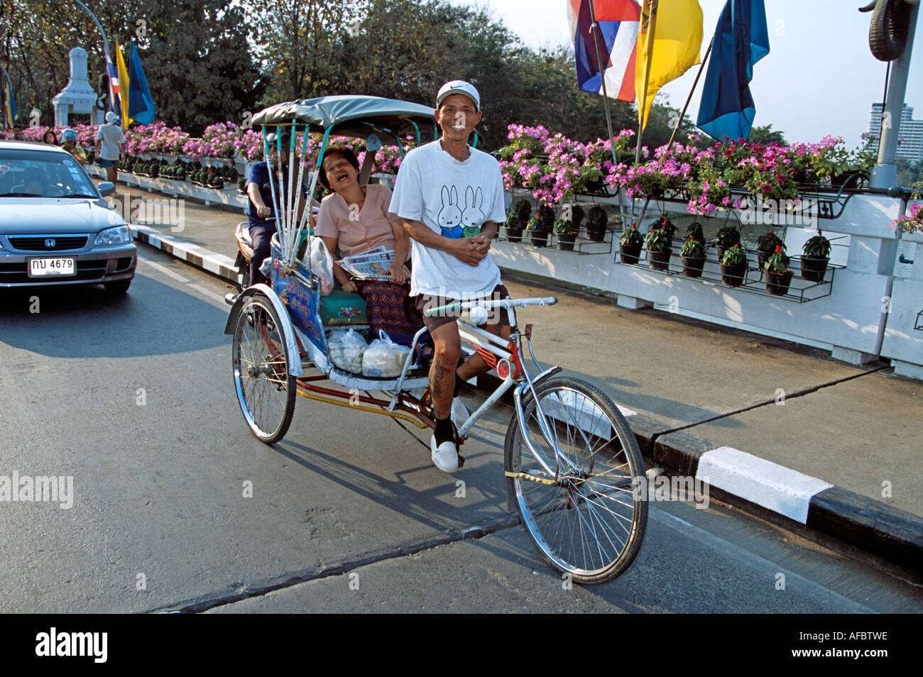 Bicycle rickshaw driver and passenger sitting in rickshaw, Chiang Mai ...