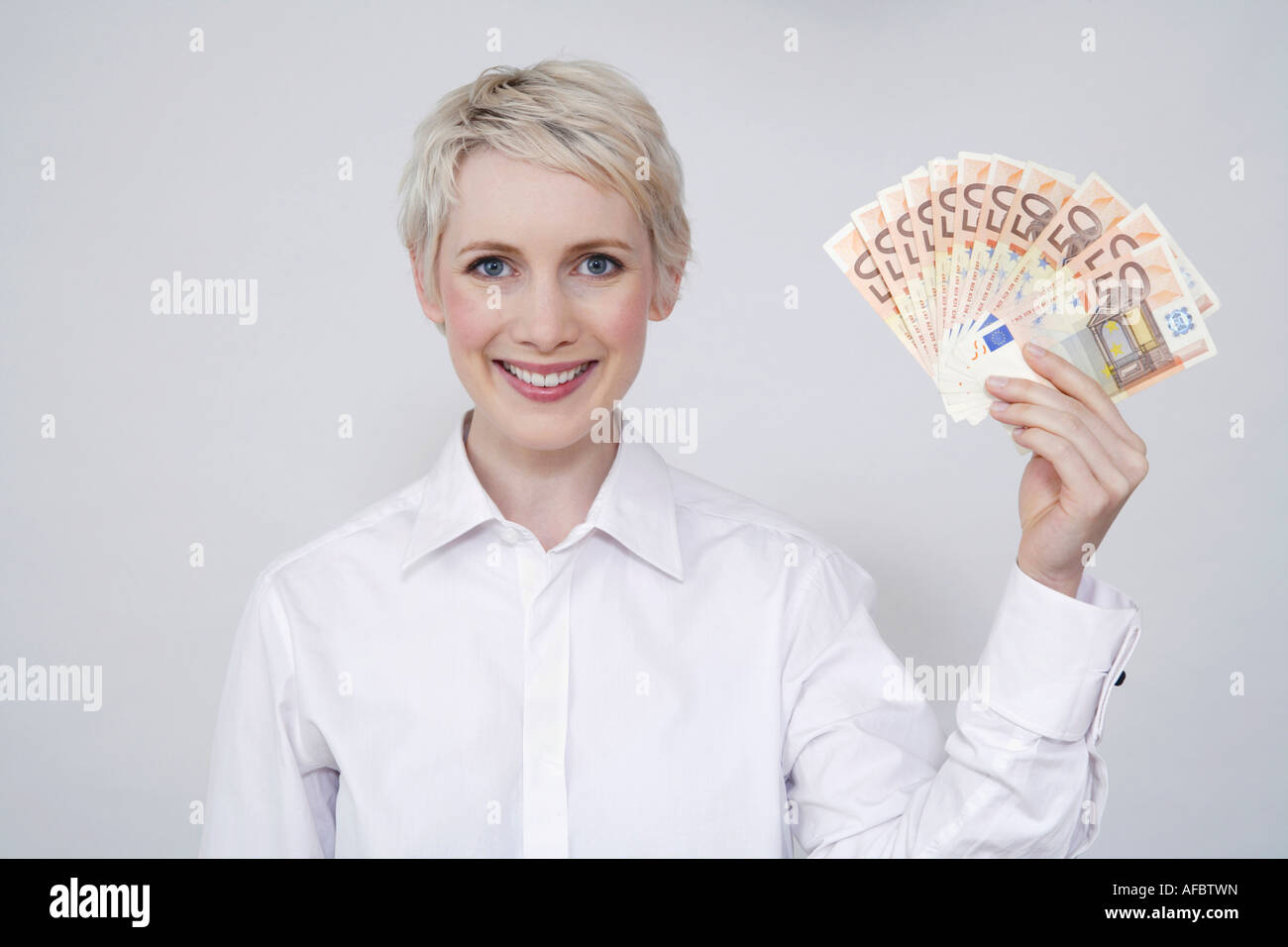 Young woman holding money, portrait Stock Photo - Alamy