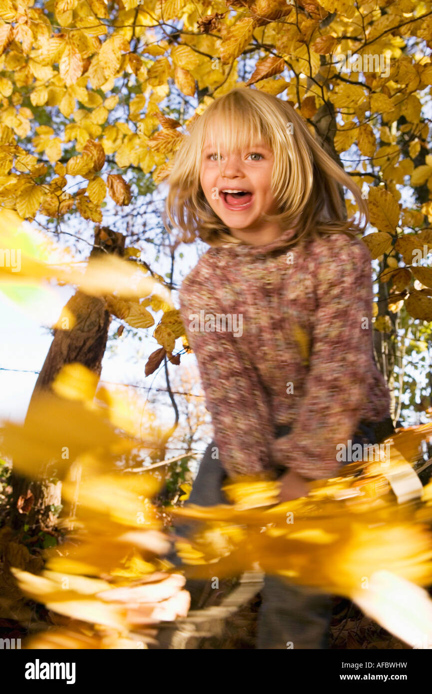 Young girl playing outdoors Stock Photo - Alamy