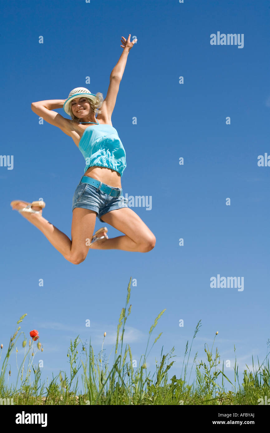 Germany, Bavaria, Young woman jumping in meadow Stock Photo - Alamy