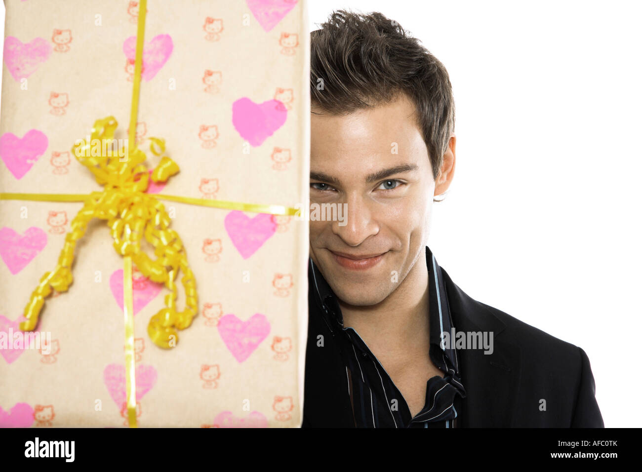 Young man holding present, close-up Stock Photo - Alamy